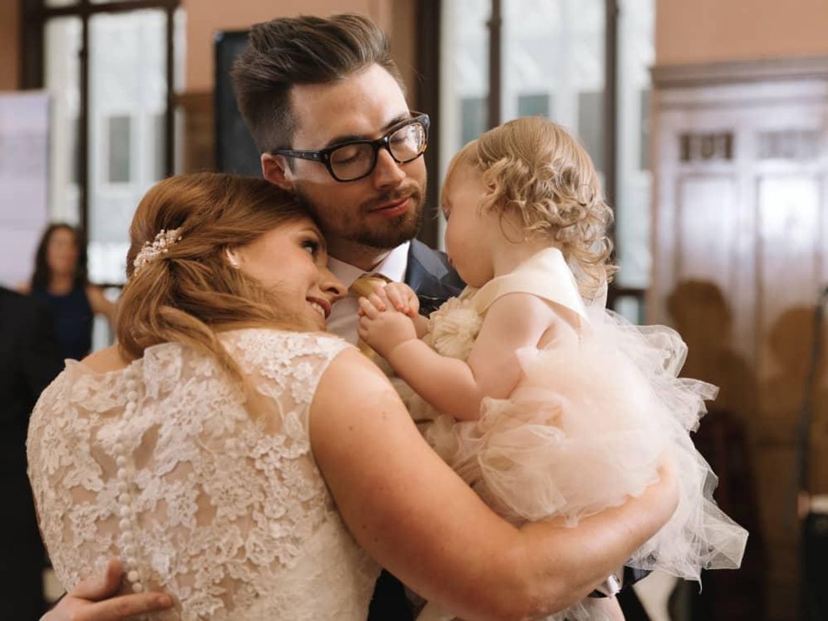 The new Mr. and Mrs. Collins with their daughter, Isla. - CultureMap Dallas