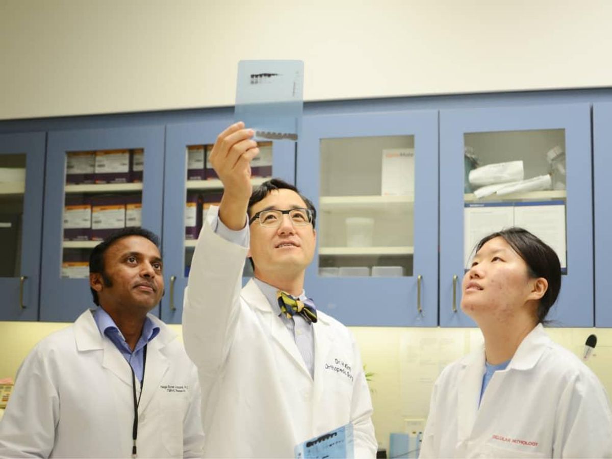 Dr. Kim and his team examine their findings. - CultureMap Dallas