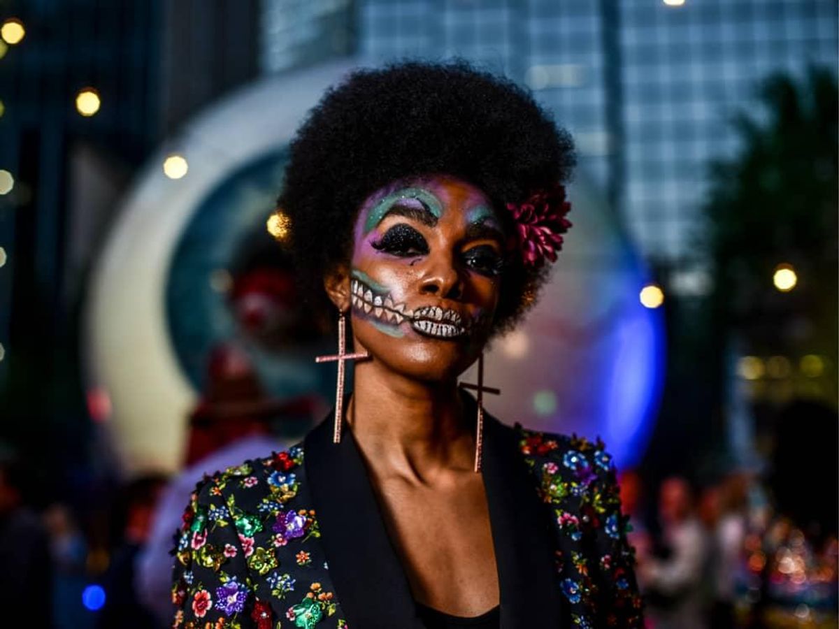 Flower-decorated models circulated thoughout the party. - CultureMap Dallas