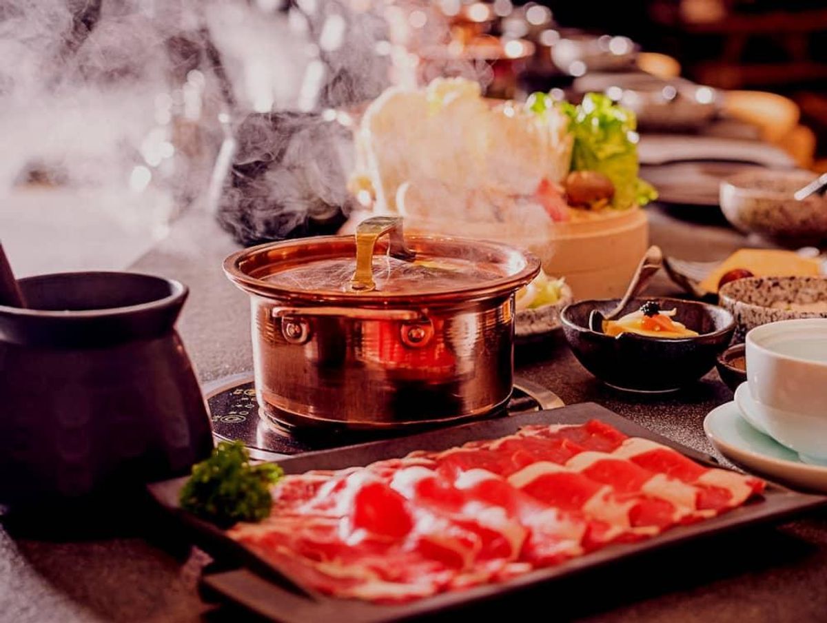 Hot pot steaming at the table. - CultureMap Dallas