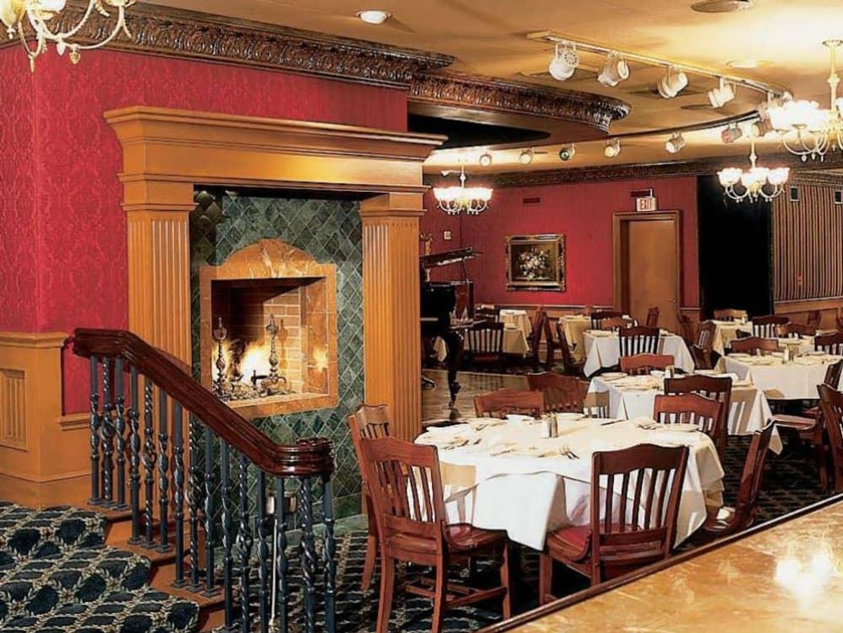 A fireplace warms up the formal dining room at III Forks. - CultureMap ...