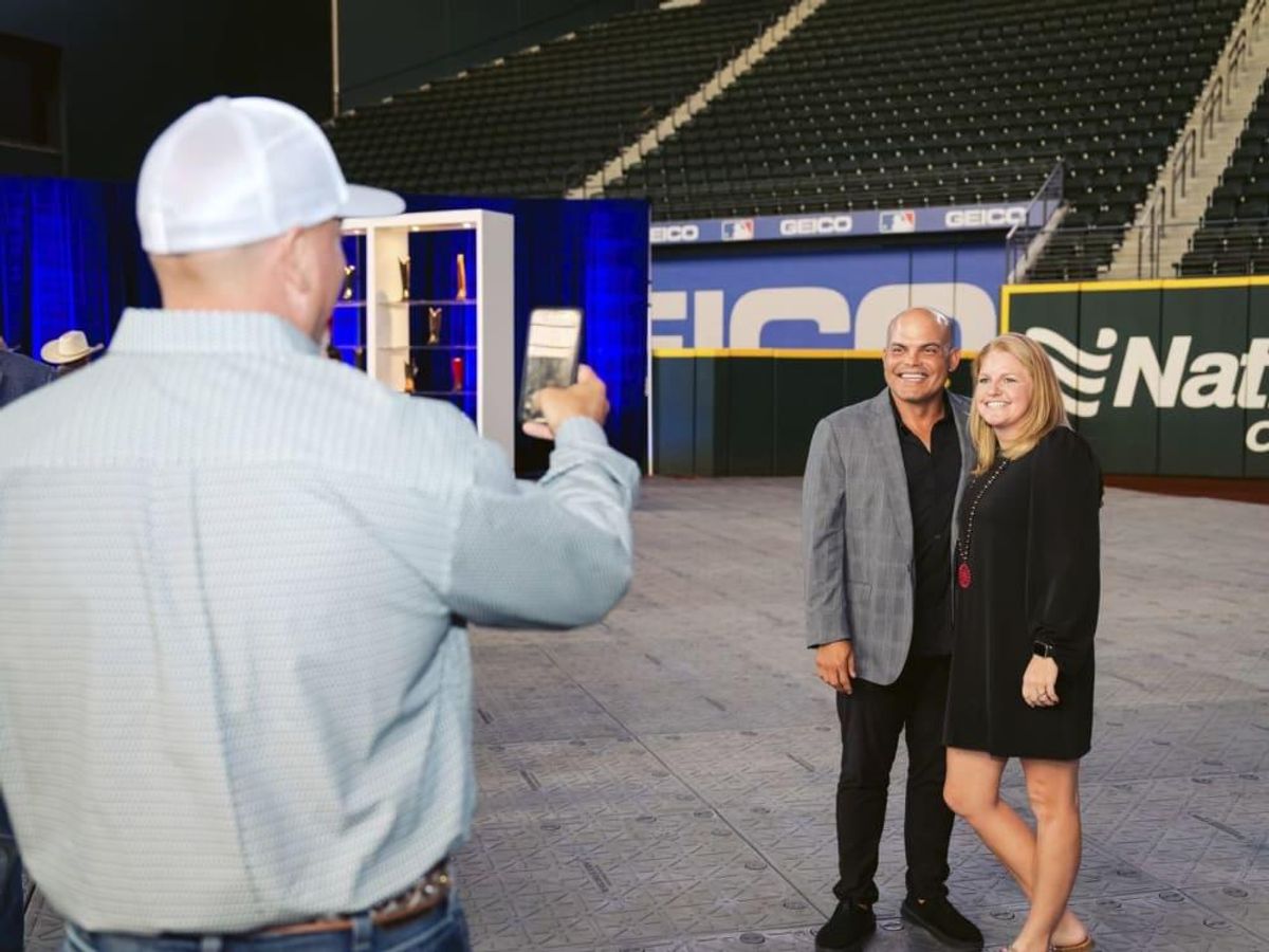 Rangers legend Ivan "Pudge" Rodriguez poses for a photo with a guest ...