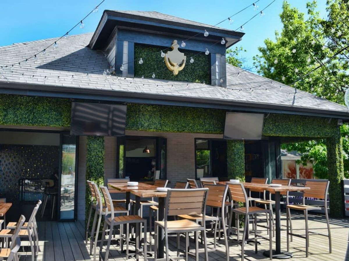 Presiding over the outdoor patio at Next Door in Uptown is the bar's ...