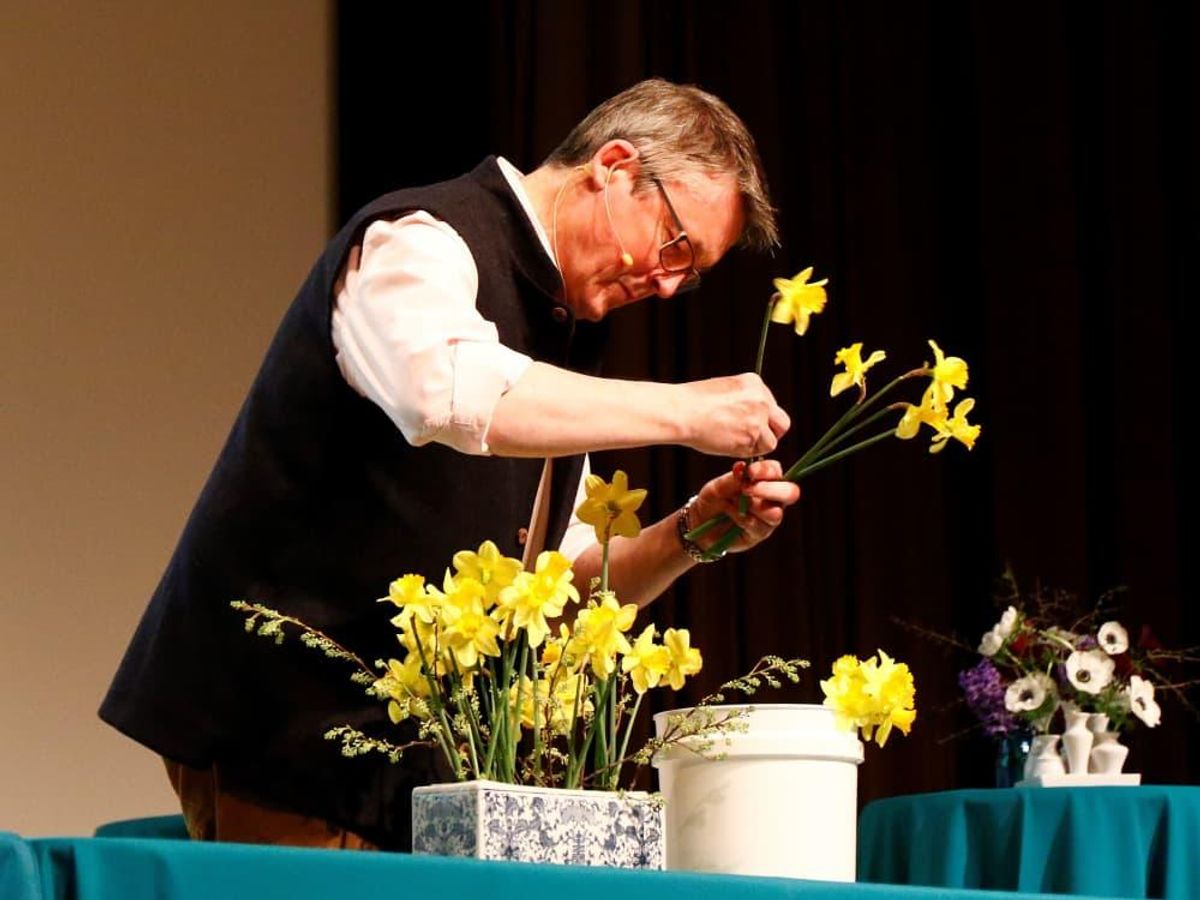 Shane Connolly arranges daffodils in a flower brick. - CultureMap Dallas