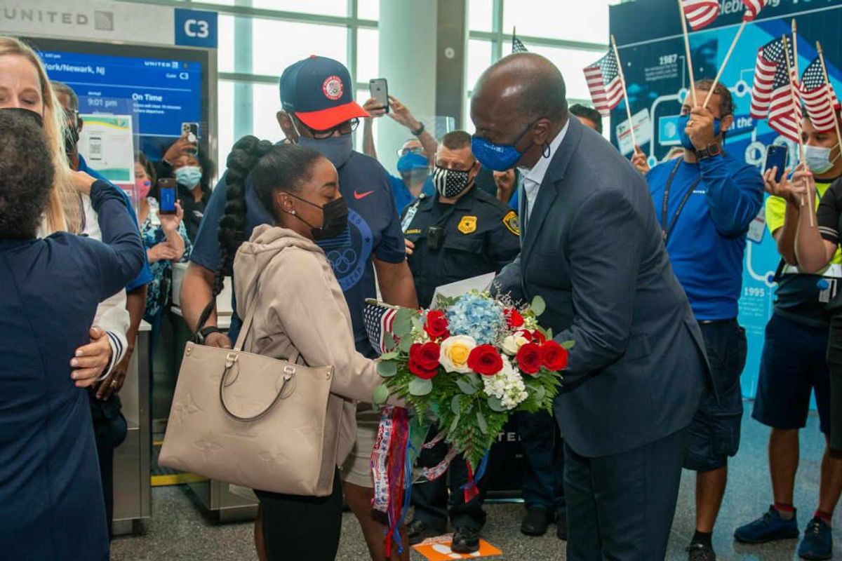 Biles was handed a large bouquet of flowers. - CultureMap Dallas