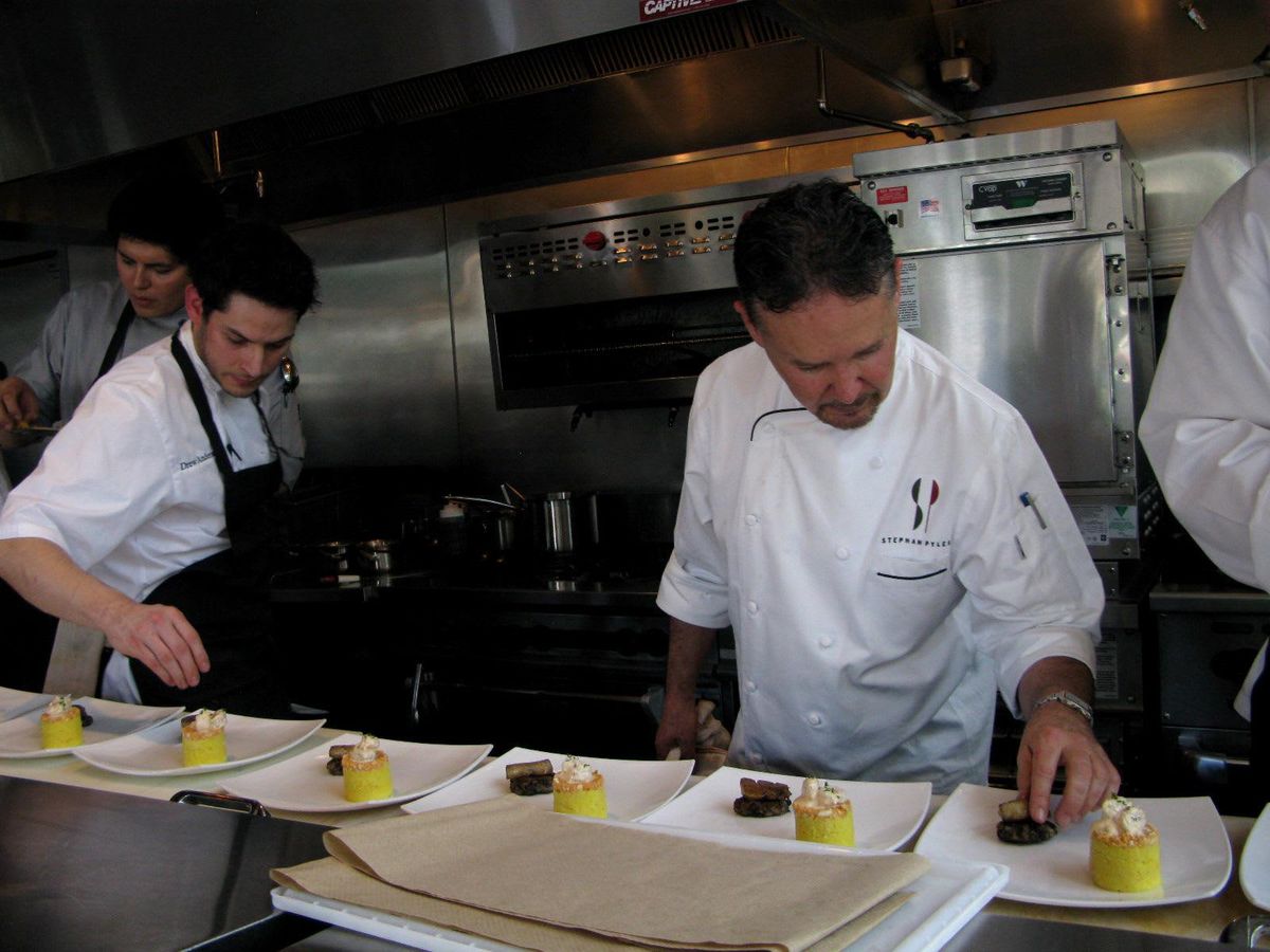 Chef Stephan Pyles oversees assembly of a plate. - CultureMap Dallas